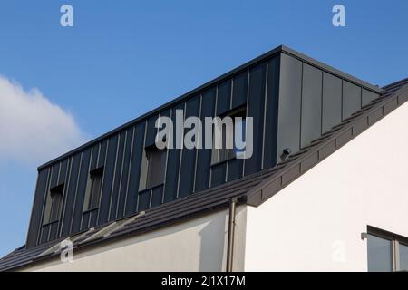 Newly tiled roof with large dormer with standing seam cladding Stock ...
