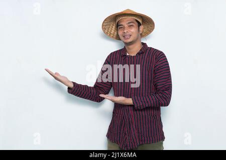 happy asian farmer pointing with fingers to different directions ...