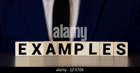 examples word written on wood block. examples text on table, concept ...
