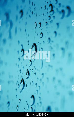 Raindrops on a window with rivulets of water runnng down the pane Stock ...