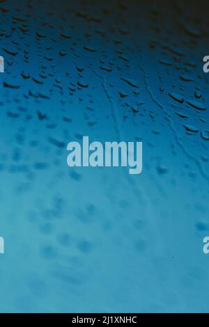 Raindrops on a window with rivulets of water runnng down the pane Stock ...