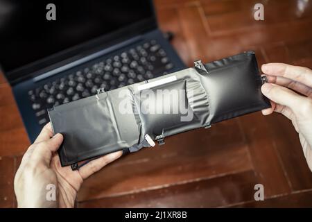 Lithium-ion laptop battery that has swollen Stock Photo - Alamy