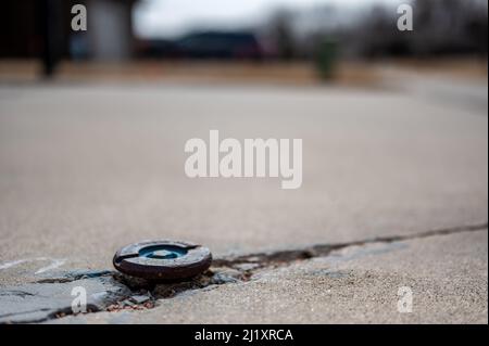 Water shutoff valve extending above a cracked concrete residential ...