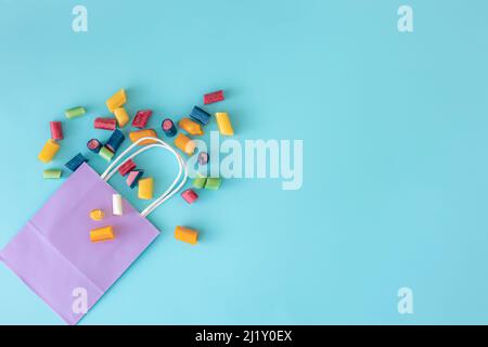 Flat lay, paper bag and chewing bags on a blue background Stock Photo ...