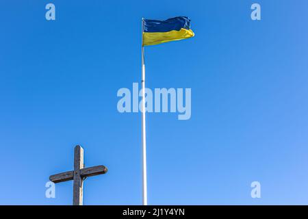 The crucifixion of Jesus Christ and the flag of Ukraine against the ...