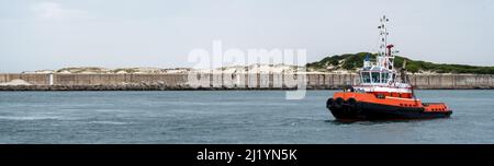 Orange tugboat and white and blue cruise ship moored at dock, Port of ...