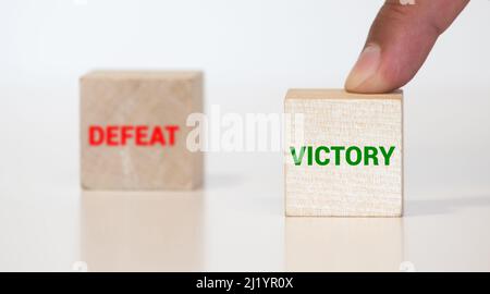 Antonym concept of VICTORY versus DEFEAT written over tarmac, road ...