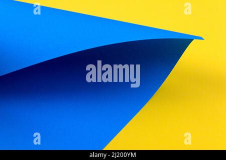 Blue and yellow paper is curved by a wavy line. Background of shape and ...