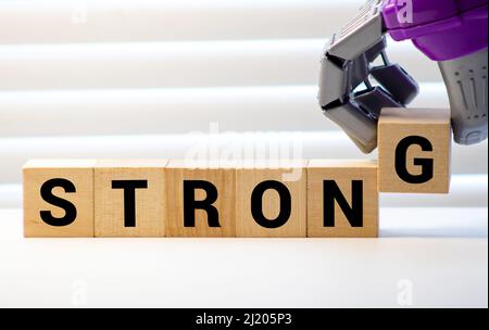 STRONG word on wood blocks concept, business Stock Photo - Alamy