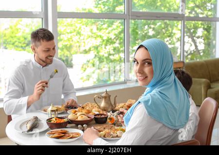 Muslim family having breakfast together. Celebration of Eid al-Fitr ...