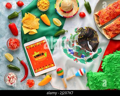 Traditional Mexican food and tablet computer on color background. Cinco ...