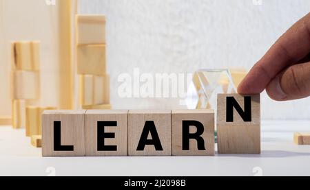 LEARN word written on wood block, concept Stock Photo - Alamy