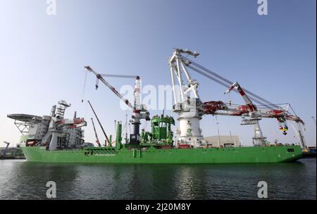 the Orion Offshore Heavy Lift crane moving wind turbine monopiles from ...
