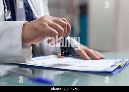 Doctor putting medical seal on prescription paper, giving medicine to ...