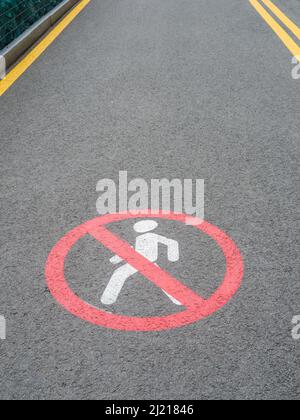 symbol for pathway and icon for pedestrians on asphalt Stock Photo - Alamy