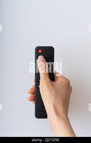 Asian hand operating remote control on white background Stock Photo - Alamy