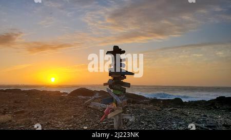 The wooden pole with direction signs against the sky. Cape Forchu ...