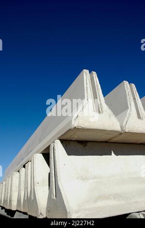 Cement Construction Barricades stacked for use on Interstate highway ...