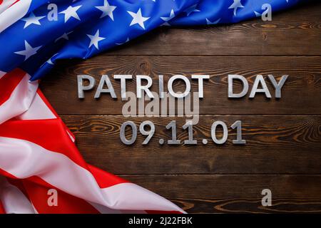 the words patriot day laid with silver metal letters on wooden board ...