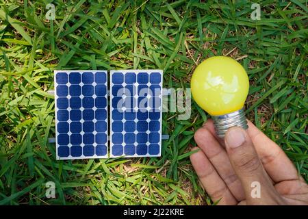 idea solar energy, hands holding light bulbs, illuminated light bulbs ...