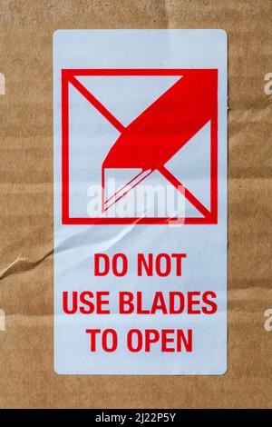 Cardboard box with warning stickers on conveyor belt Stock Photo - Alamy