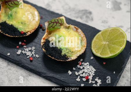 Delicacy roasted scallops with cheese spices and chuka algae Stock ...