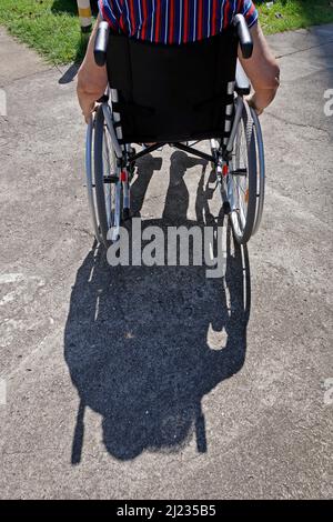 Old woman wheelchair user and her shadow Stock Photo - Alamy