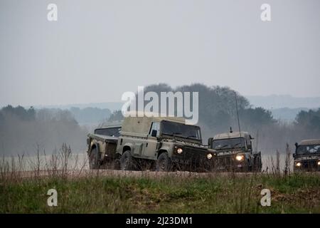 a small convoy British Army Land Rover Defender Wolf medium utility ...