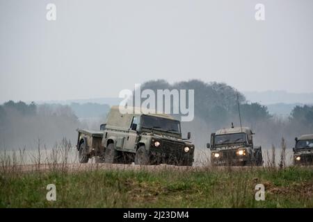 a small convoy British Army Land Rover Defender Wolf medium utility ...