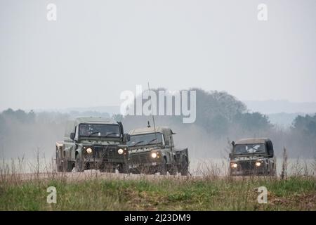 a small convoy British Army Land Rover Defender Wolf medium utility ...