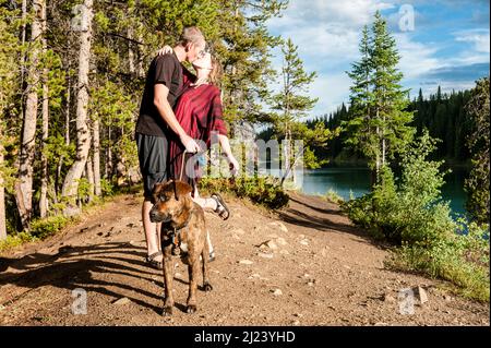 Young couple going for a swim with their dog a lake Stock Photo - Alamy