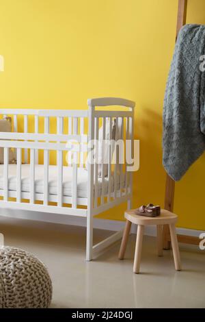 Comfortable children's bed near color wall in stylish room Stock Photo ...