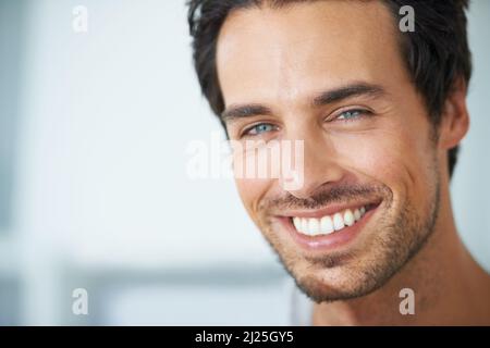 Hes got a charming smile. Portrait of a handsome young man with a big ...