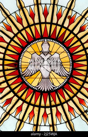 The Holy Spirit as a dove. Stained-glass window. St. Petrus and St ...