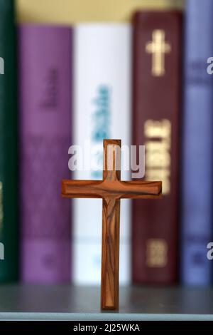 Christian bibles of different versions on a bookshelf. Religious symbol ...