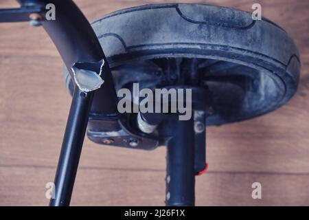 Broken chassis of a baby stroller, damage to the crossbar of the metal ...