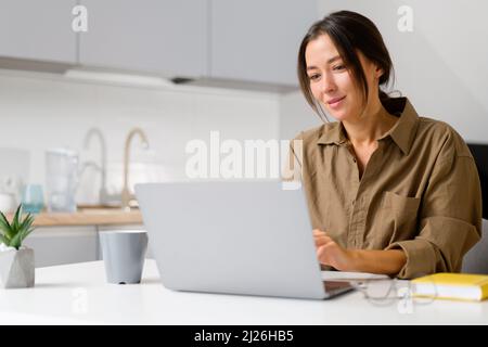 Female freelancer daydreaming with a cup of morning coffee, smiling ...