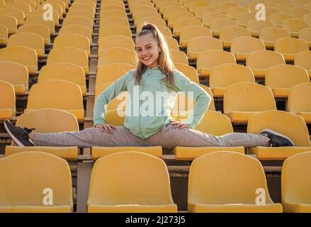 Stretch and flex for your health. Flexible tween do splits on stadium ...