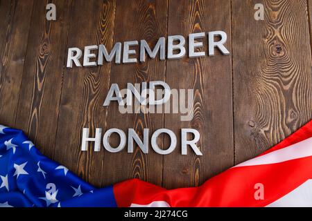 words remember and honor laid with silver metal letters on wooden ...