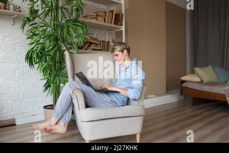 stylish guy sitting in a large comfortable armchair Stock Photo - Alamy