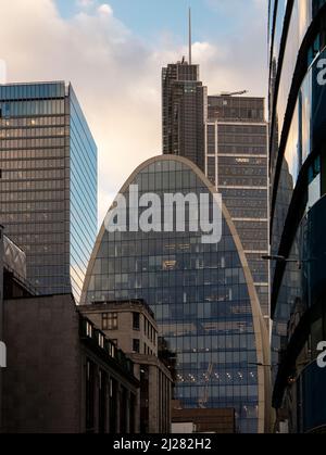 Ultra-modern skyscrapers in Aldgate, London, reflecting the cloudscape ...