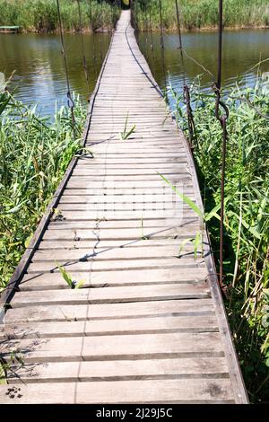 Homemade suspension bridge across the Sura River in the Dnipropetrovsk ...