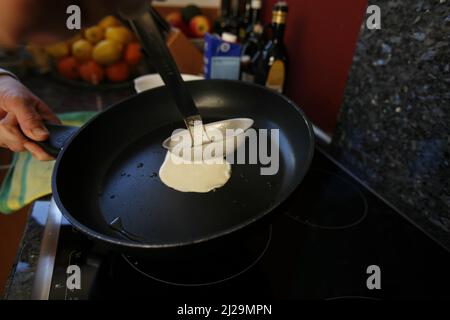 Swabian cuisine, pancakes, frying flaedle in the pan, spatula ...