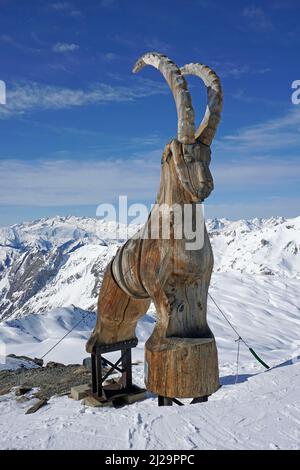 Wooden ibex figure, work of art, snow-capped mountains, La Masse peak ...