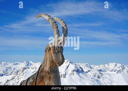 Wooden ibex figure, work of art, snow-capped mountains, La Masse peak ...