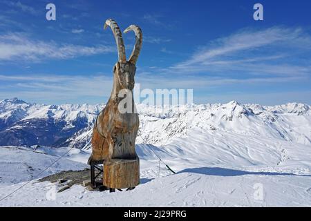 Wooden ibex figure, work of art, snow-capped mountains, La Masse peak ...