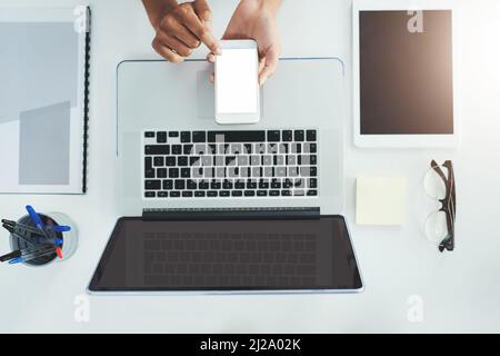 Staying in touch. Shot of an unrecognizable young businesswoman using ...