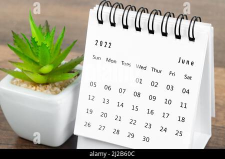 The June 2022 desk calendar with plant pot on wooden table Stock Photo ...