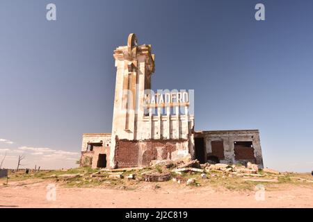 The blue sky over collapsed Slaughterhouse in Villa Epecuen on a sunny ...