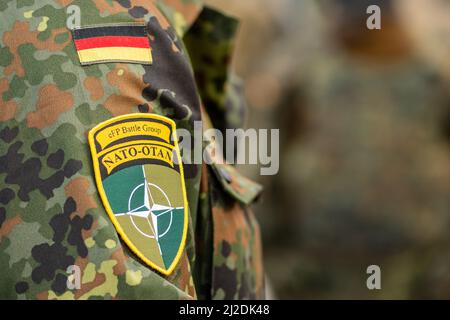 Flag of Germany and symbol of NATO battle group on a soldier uniform ...